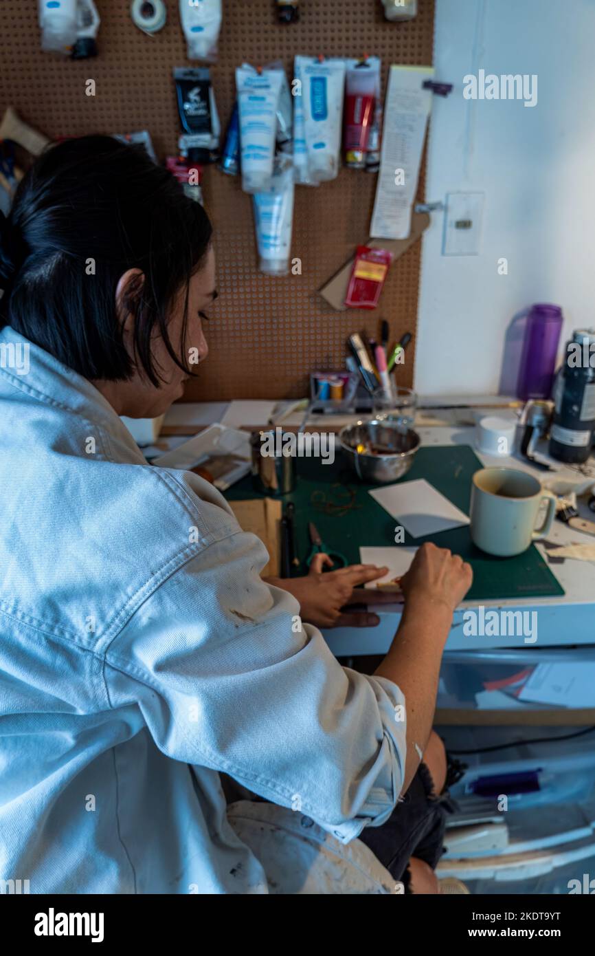 painting on blank canvas, hispanic woman with brushes and oil painting ...