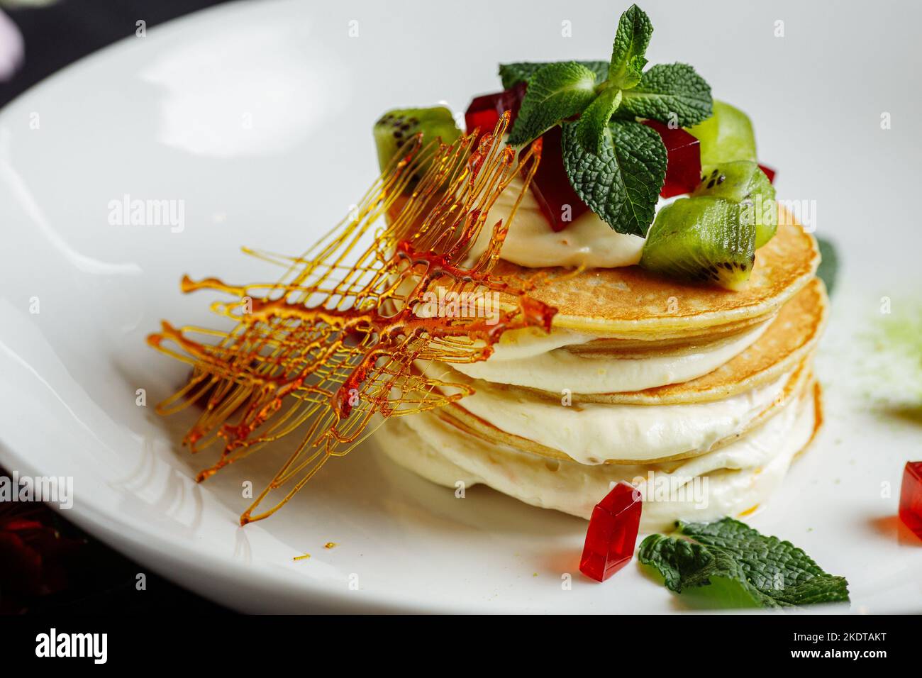 a pile of fritters with cream on a gray blue plate Stock Photo - Alamy