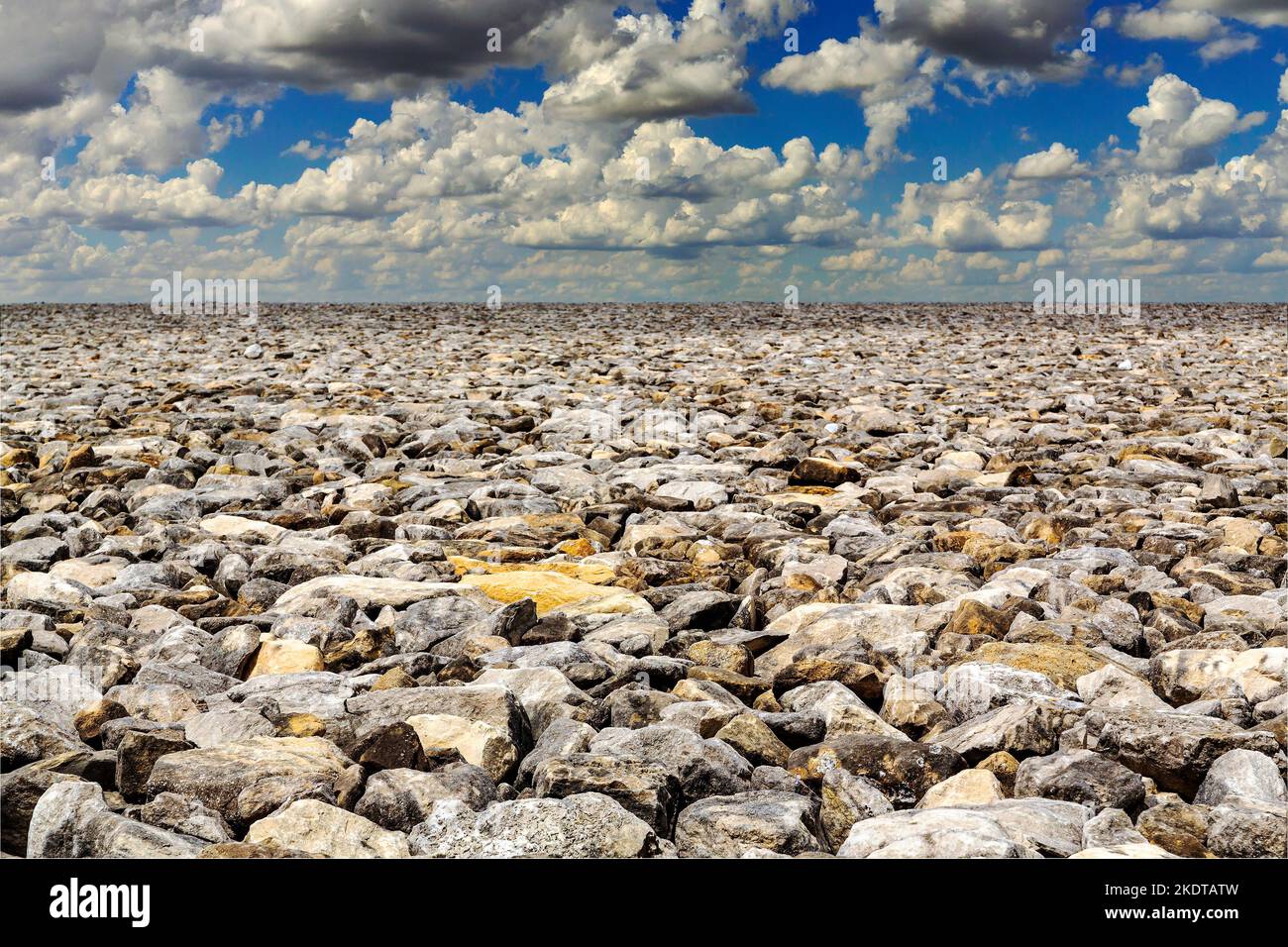 Landscape of a rocky barren wasteland stretching to the horizon under a ...