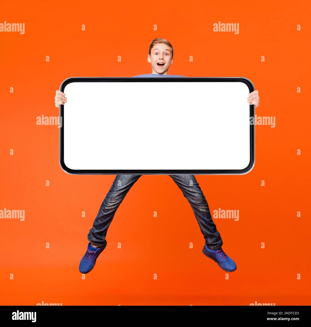 Mobile Ad. Excited Preteen Boy Jumping With Huge Blank Smartphone In ...