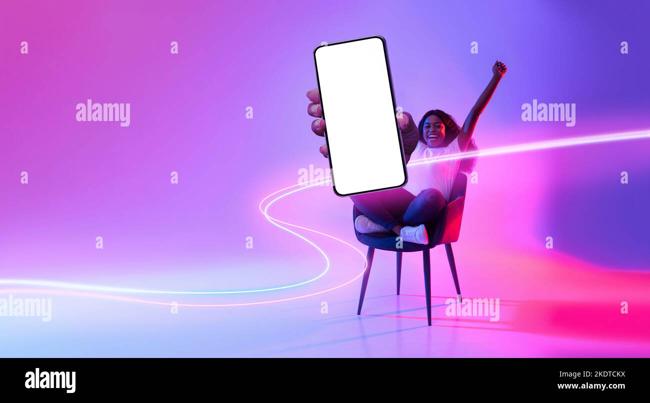 Happy black lady raising hands up, showing cell phone, mockup Stock ...