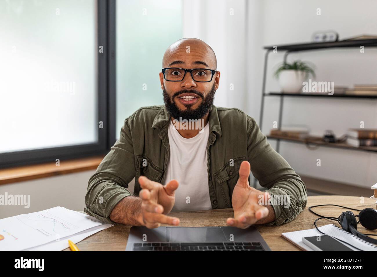 Head shot portrait of mature male employee talking on video call with ...