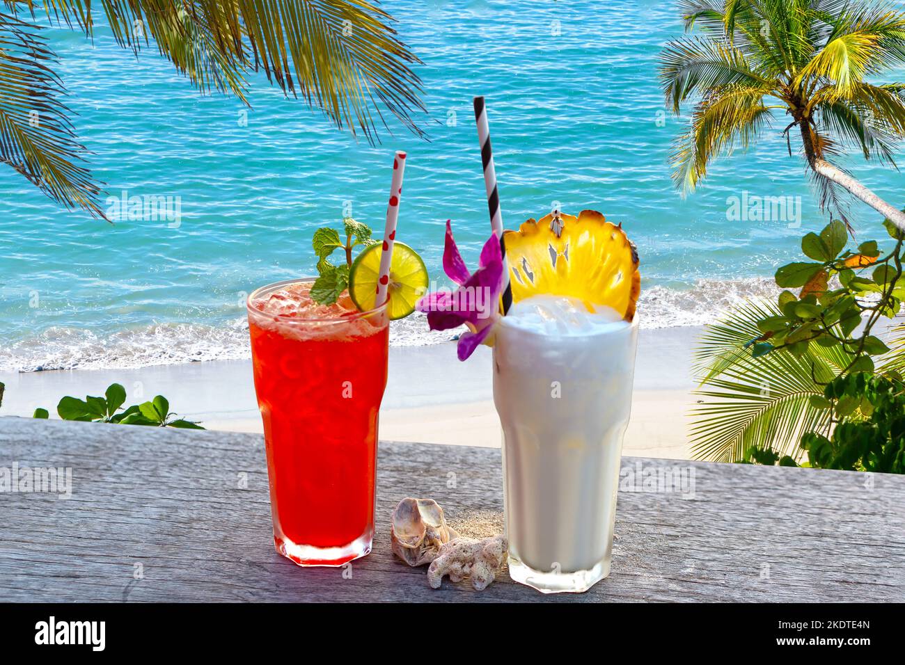 two drinks with a beach in the background Stock Photo - Alamy