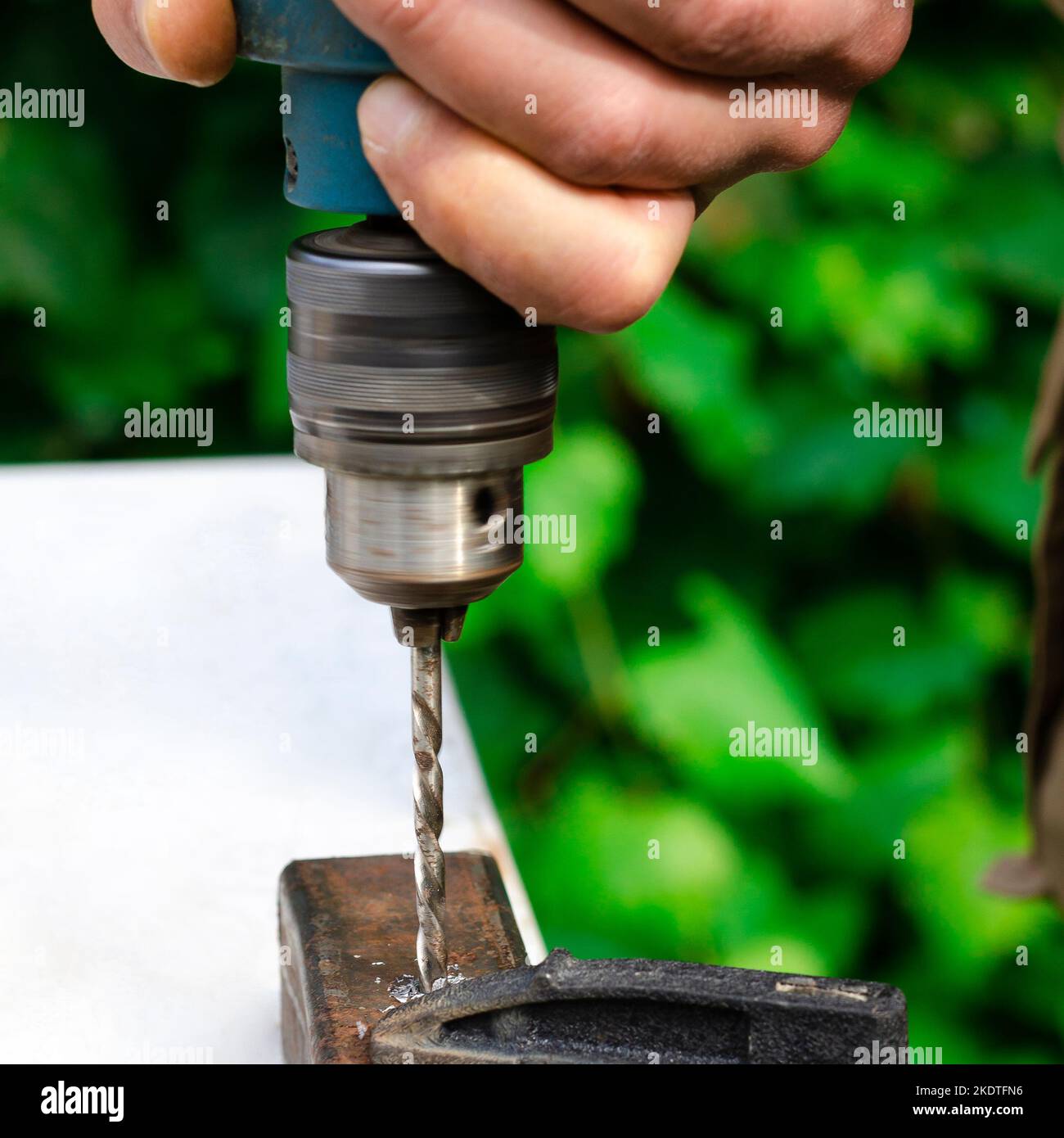 Men's hands with a drill. Working with metal Stock Photo - Alamy