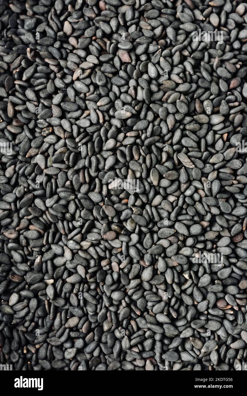 Black sesame seeds close up textured background Stock Photo - Alamy