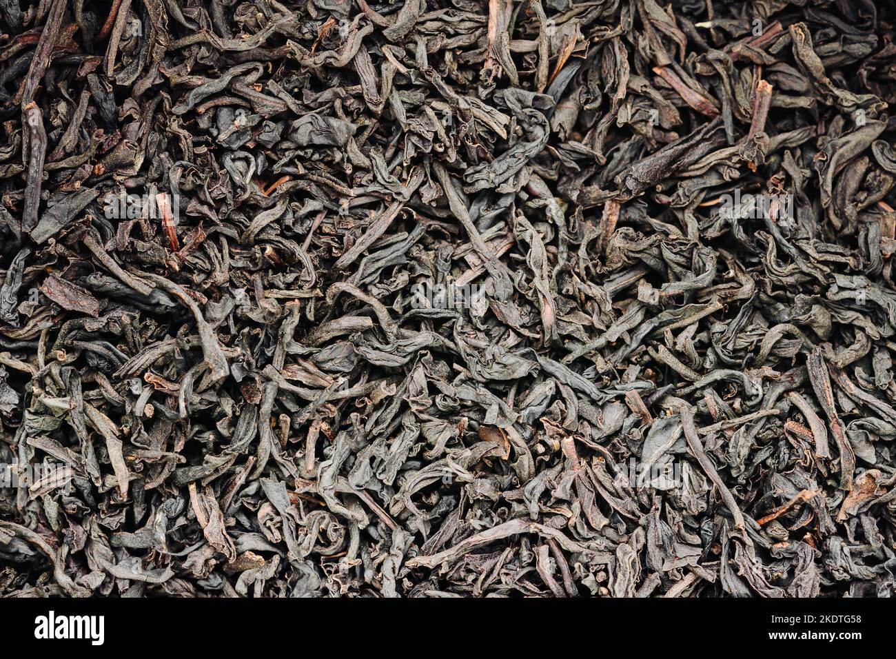 Dry black tea leaves, texture, closeup background Stock Photo - Alamy