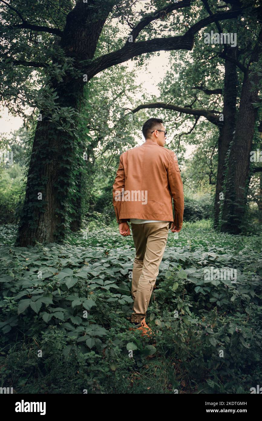 Back view male tourist walks hi-res stock photography and images - Alamy