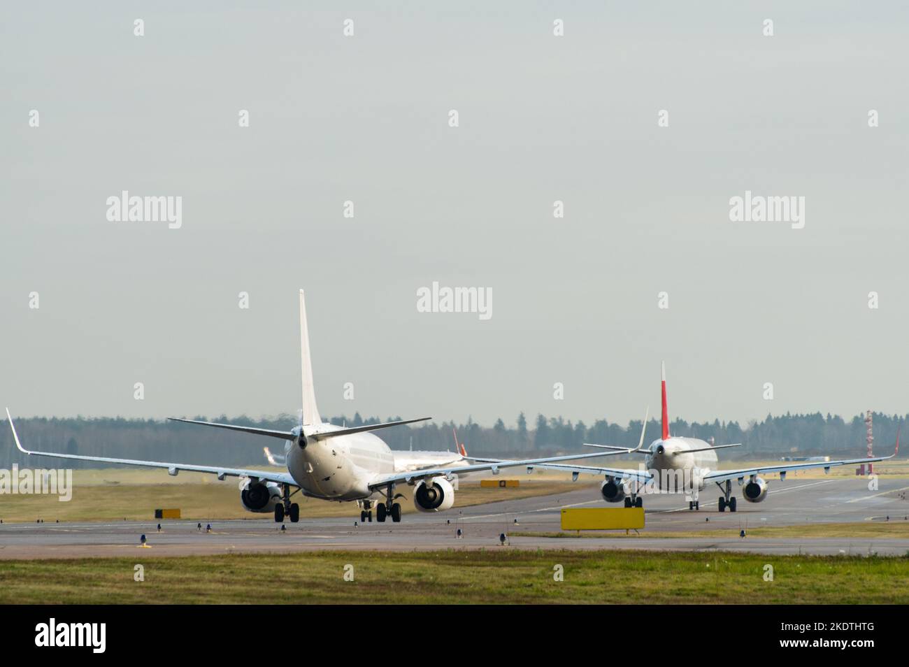 A modern passenger plane in white livery at the international airport ...