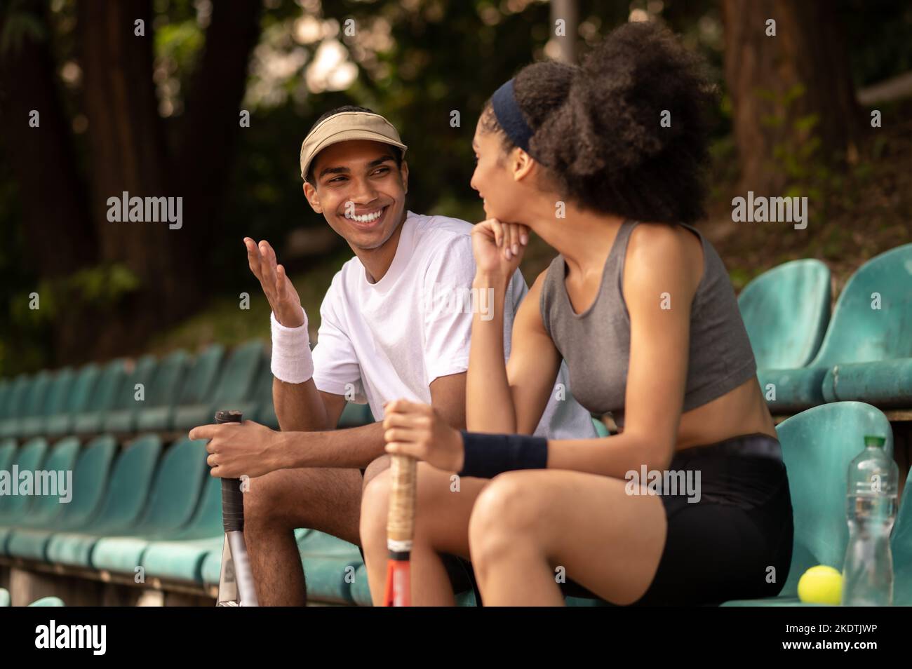 Two young people discussing the match and looking excited Stock Photo ...