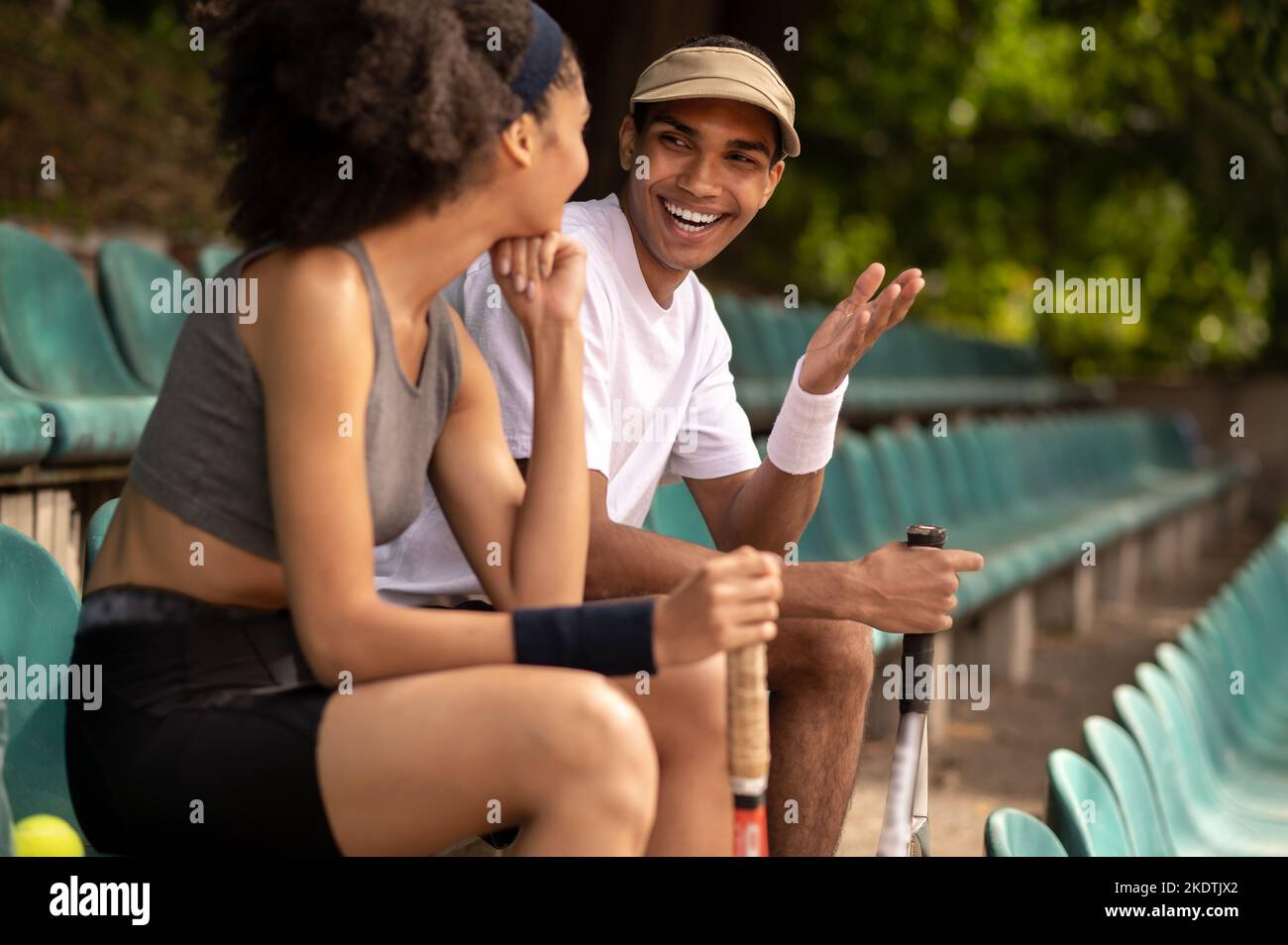 Two young people discussing the match and looking excited Stock Photo ...
