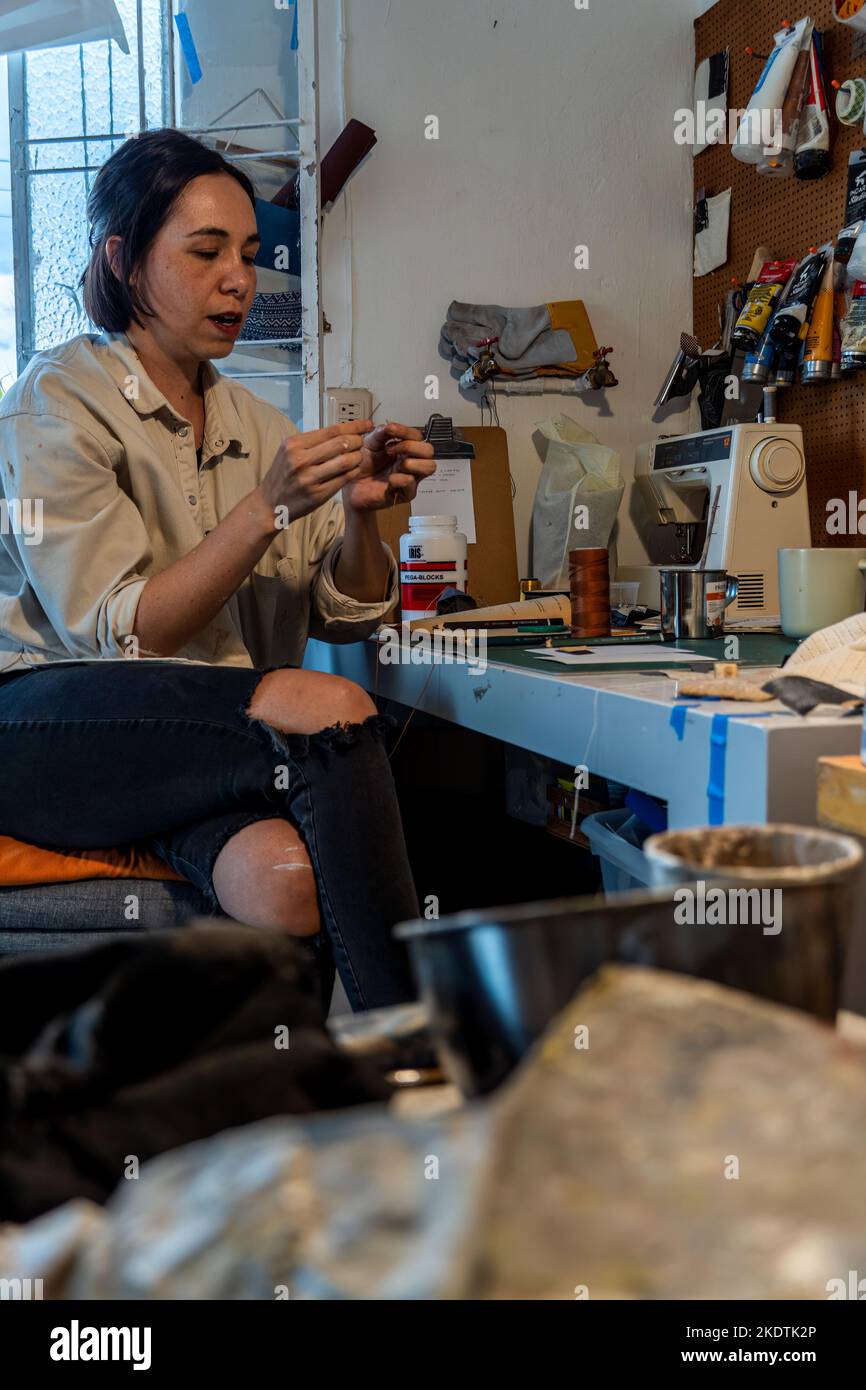 art workshop, messy objects, brushes, paint all mixed up disorganized ...