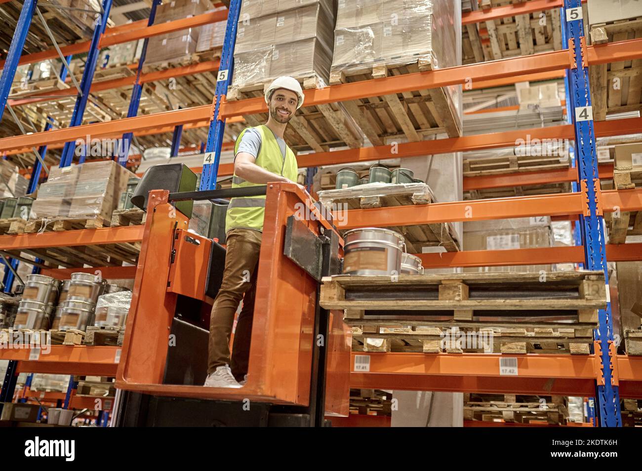 Joyous warehouse employee posing for the camera at work Stock Photo - Alamy