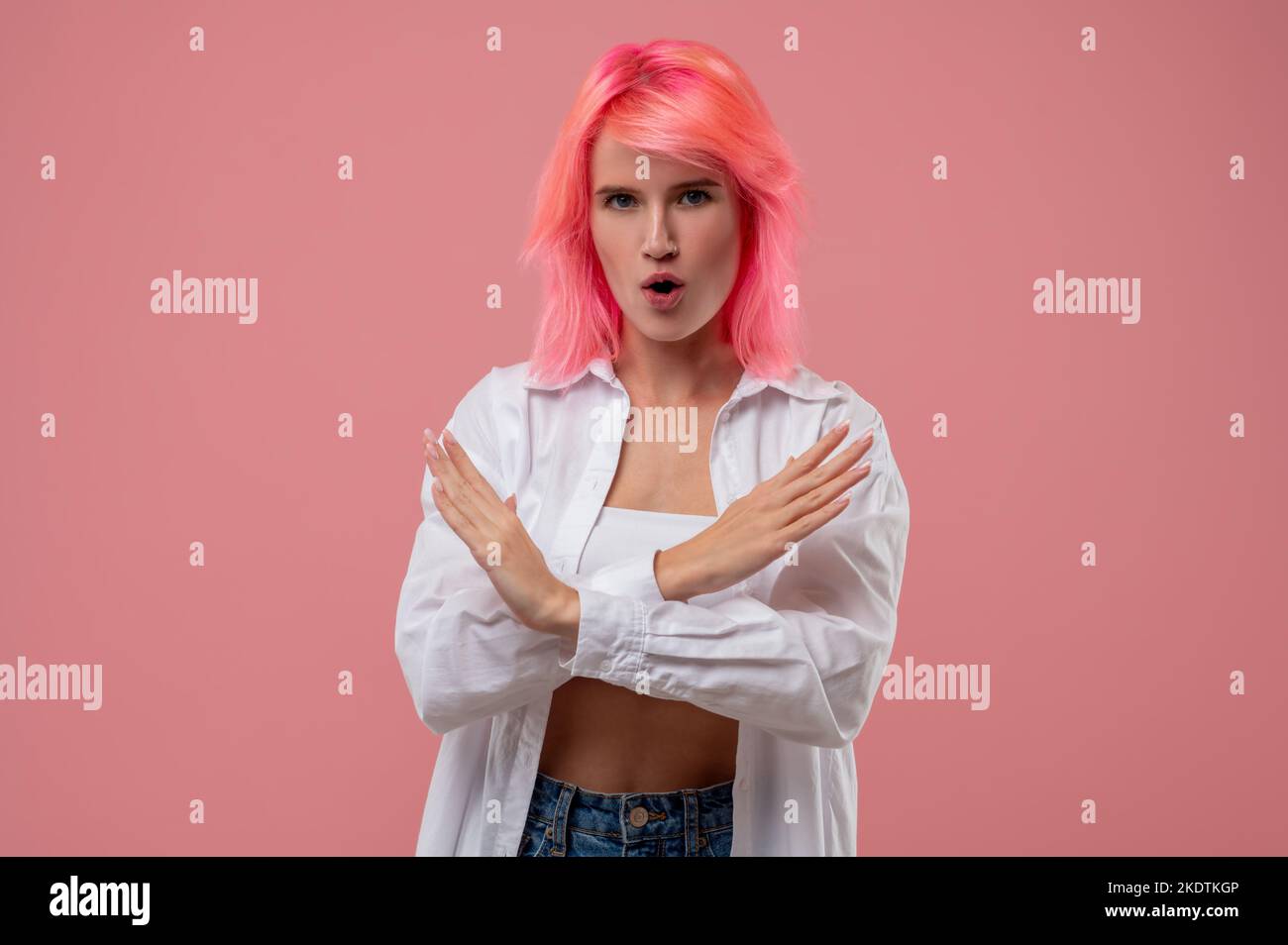 Resolute woman standing in a closed pose before the camera Stock Photo ...