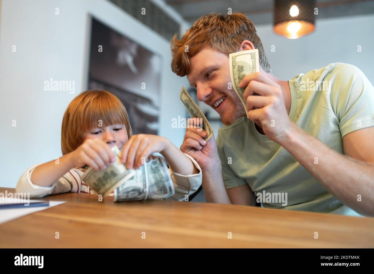 Dad explaining his son the importance of financial literacy Stock Photo ...