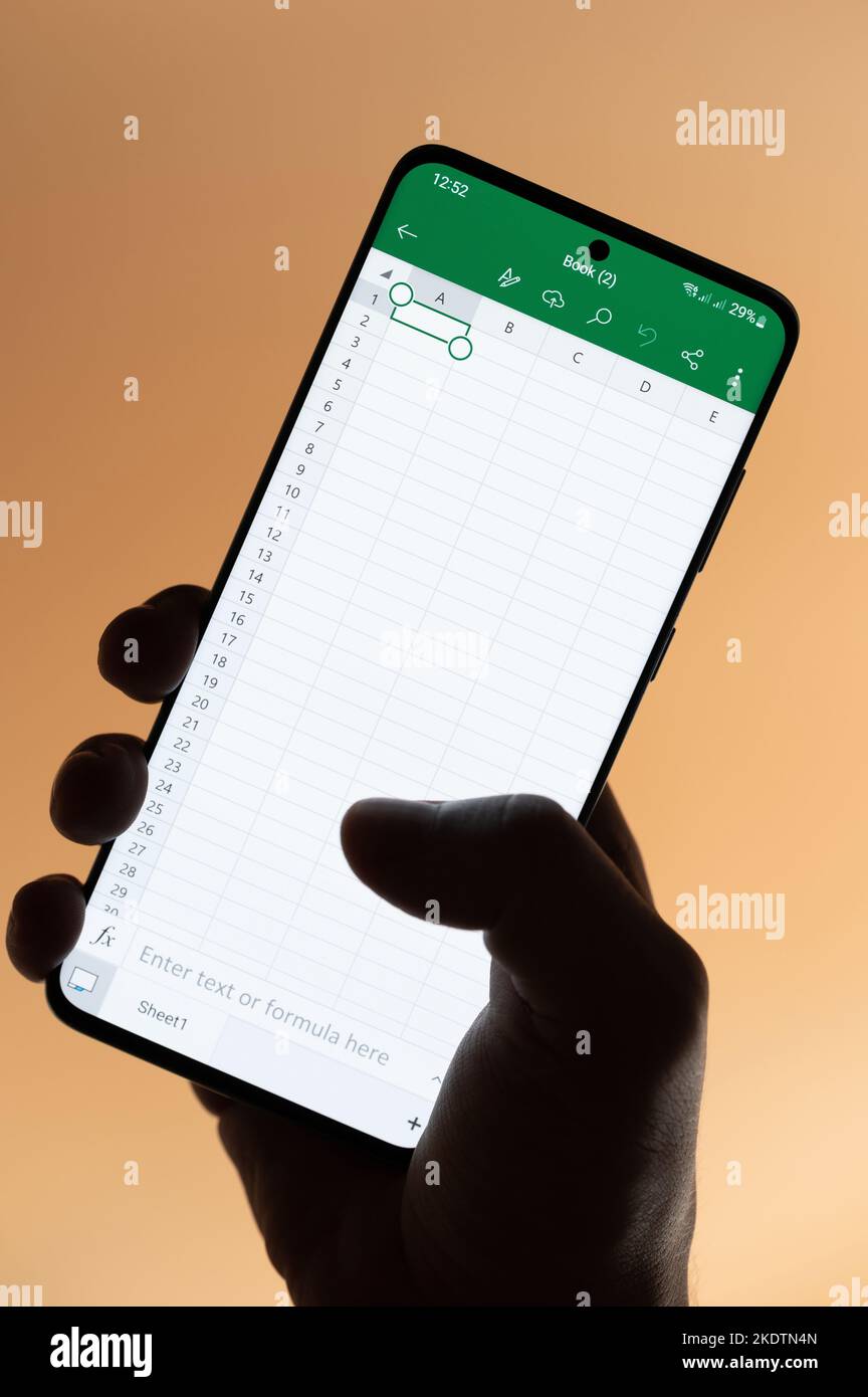 New york, USA - November 4, 2022: Using Microsoft excel app on smartphone holding in hand ...