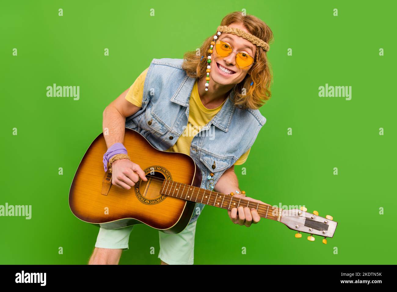 Portrait of handsome trendy cheery guy playing guitar singing hit ...