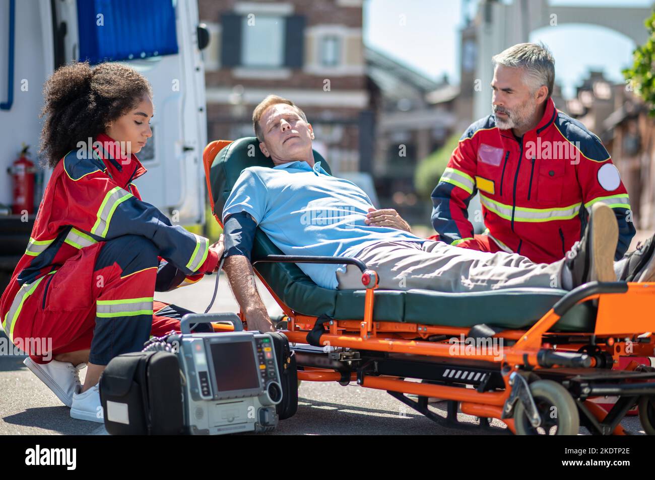 Ambulance staff providing emergency medical service to an unconscious ...