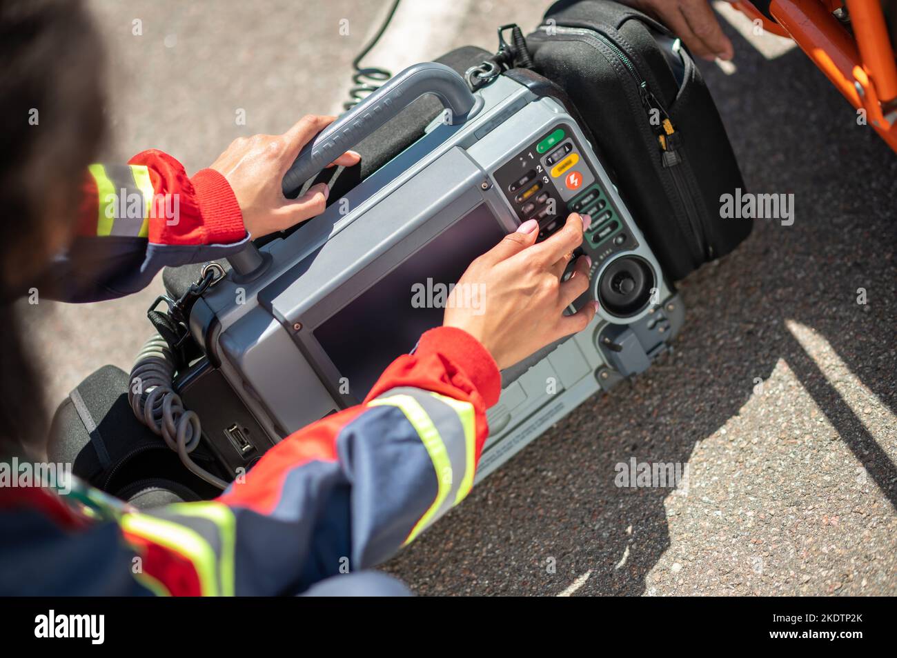 Paramedic preparing the ECG device for electrocardiography Stock Photo ...