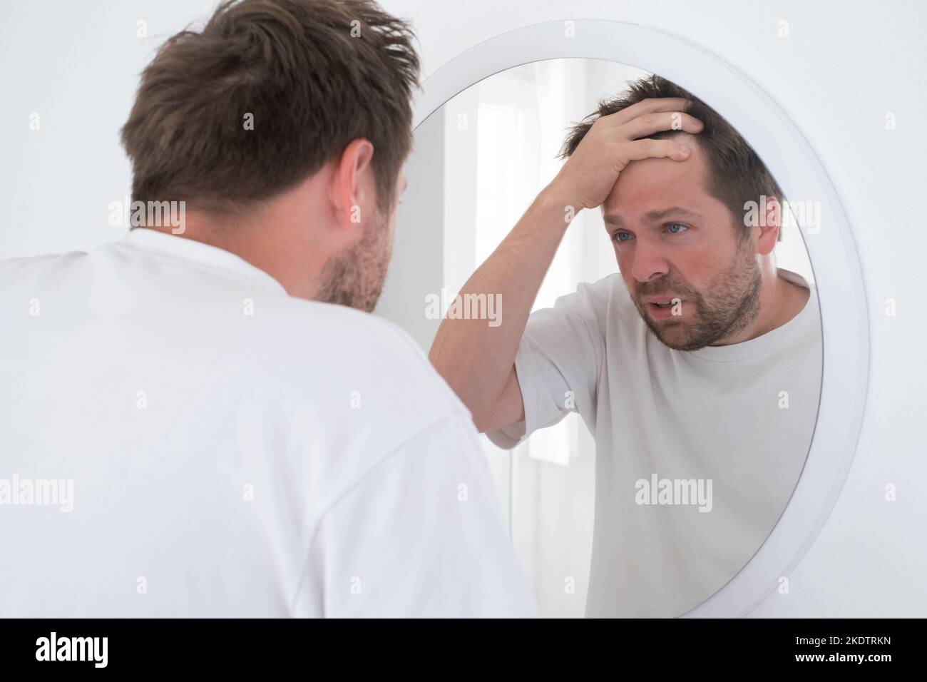 Man Looking In Mirror Sad