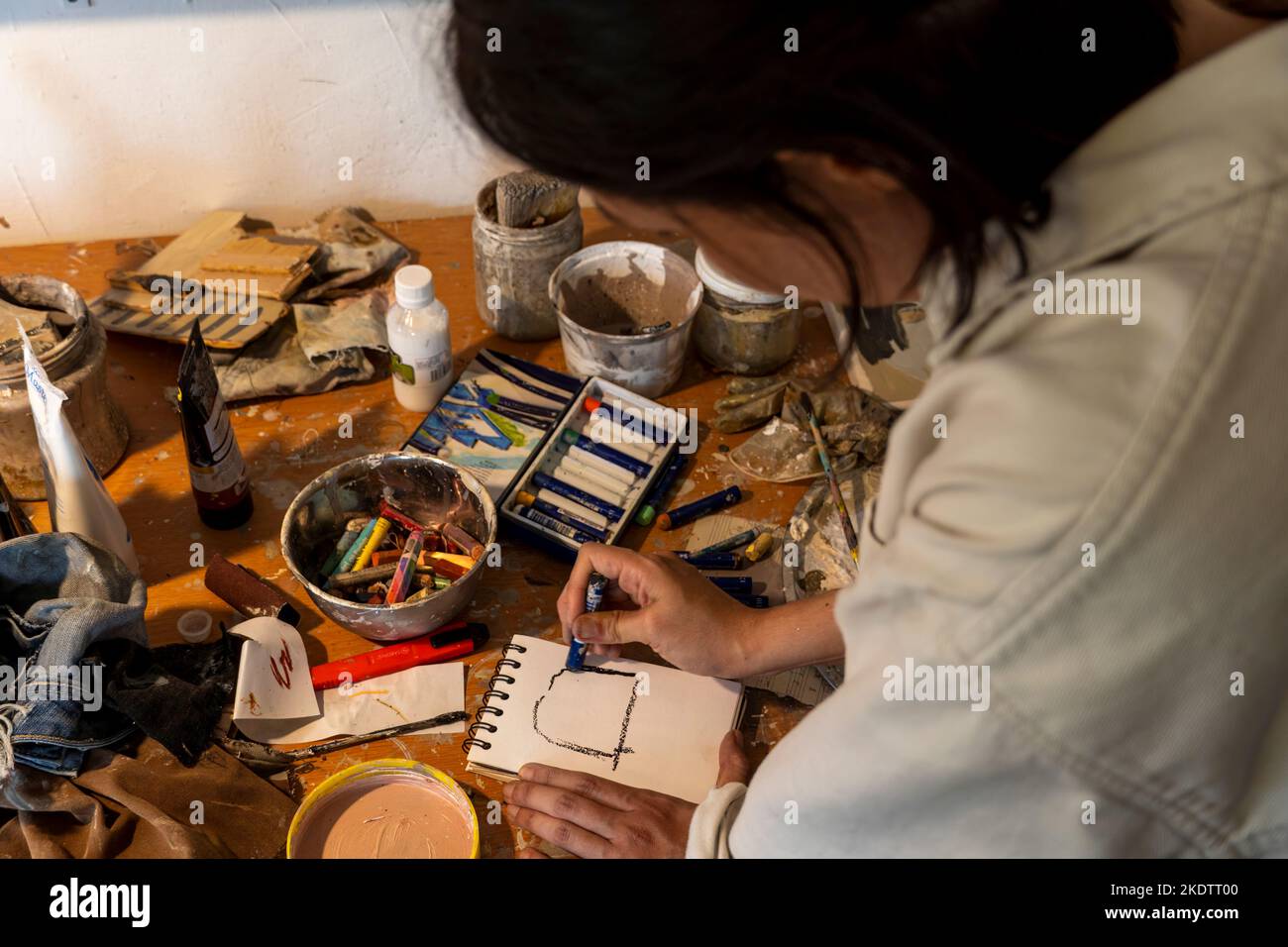 art workshop, messy objects, brushes, paint all mixed up disorganized ...