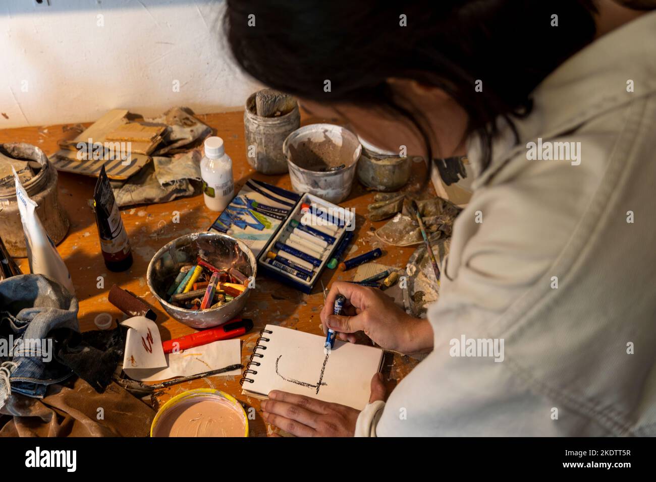 art workshop, messy objects, brushes, paint all mixed up disorganized ...
