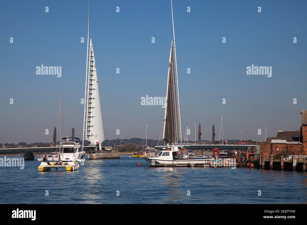 Motor boats in Poole Harbour with the Twin Sails Bridge beyond, Poole ...