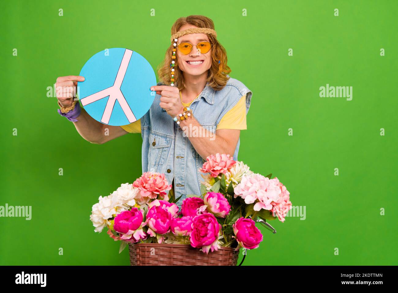 Portrait of friendly handsome man hands hold showing peace symbol badge ...