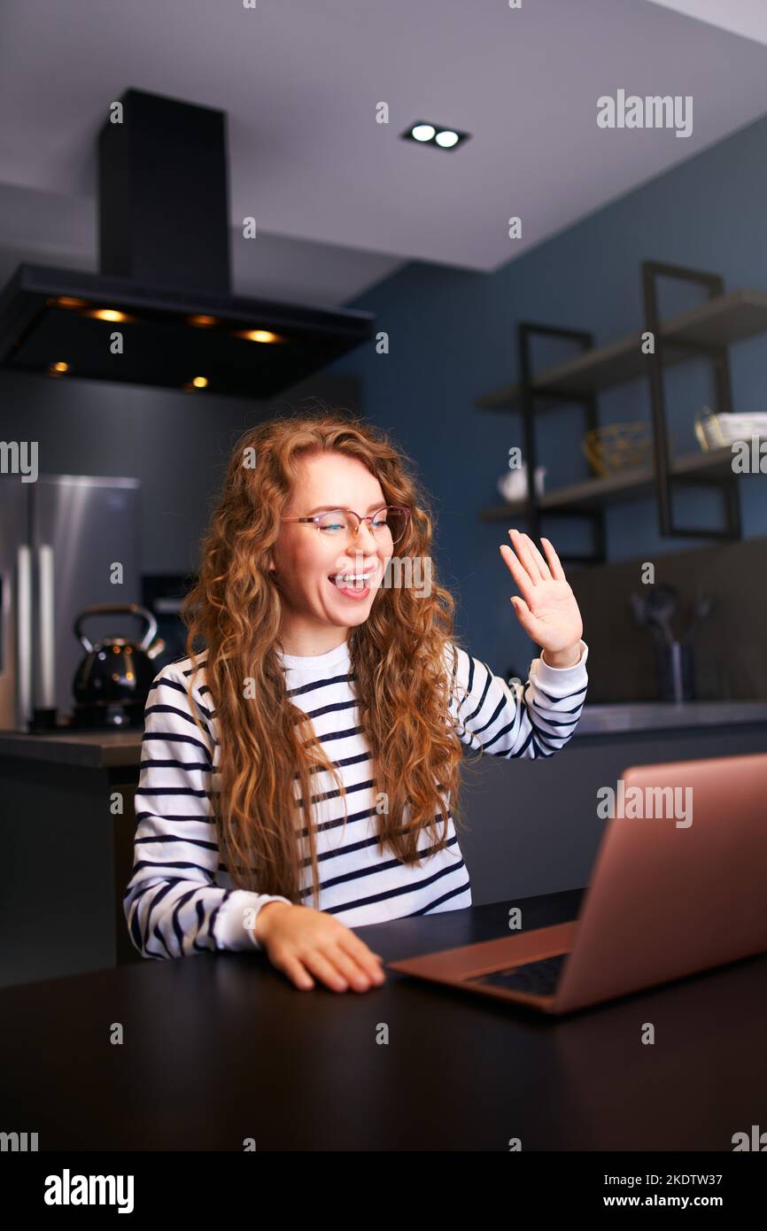 Woman talking on video chat conference with friends on laptop webcam ...