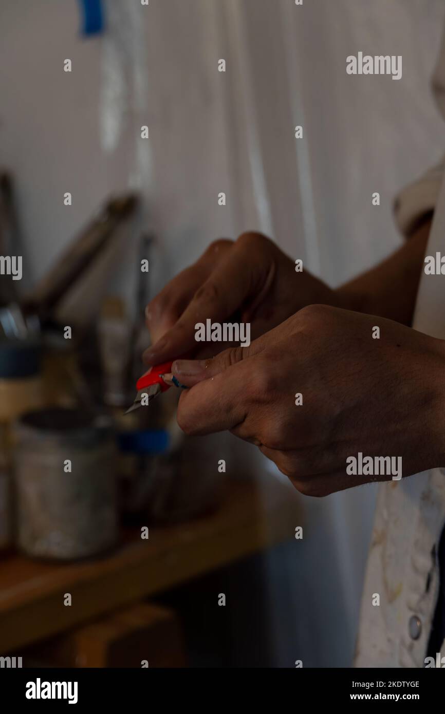 art workshop, messy objects, brushes, paint all mixed up disorganized ...