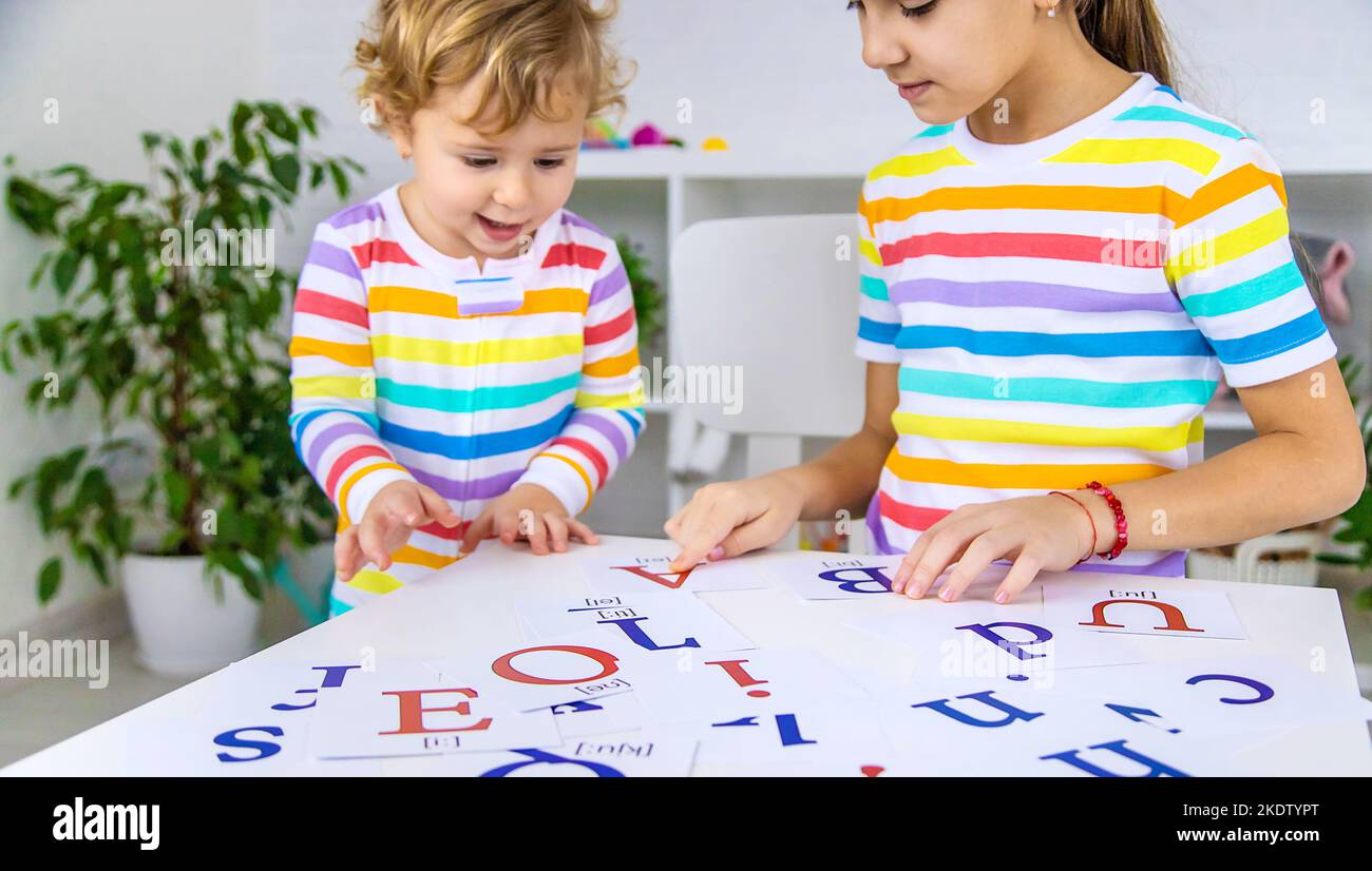 The child learns English letters. Selective focus. Kid Stock Photo - Alamy
