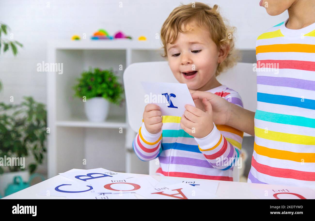 The child learns English letters. Selective focus. Kid Stock Photo - Alamy