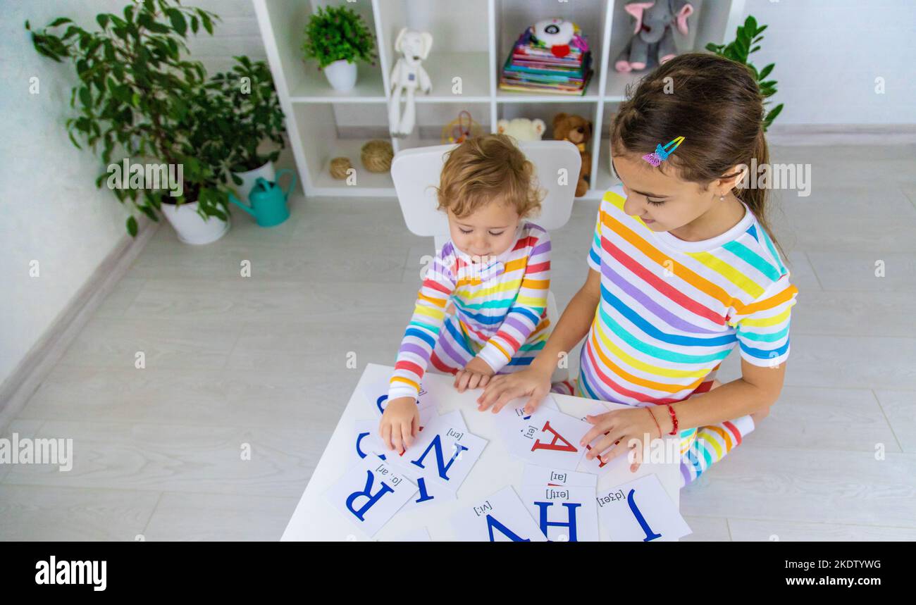 The child learns English letters. Selective focus. Kid Stock Photo - Alamy