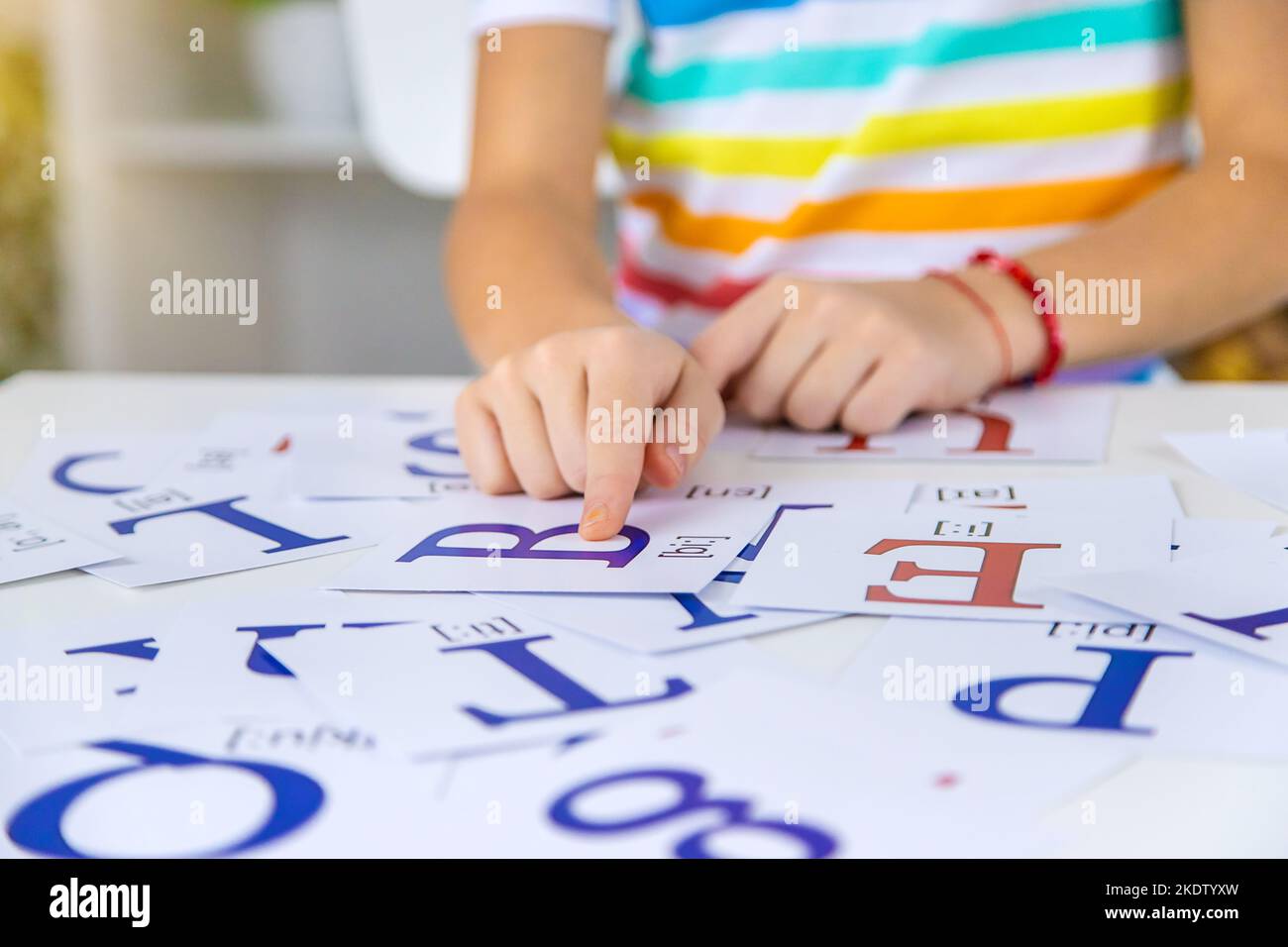 The child learns English letters. Selective focus. Kid Stock Photo - Alamy