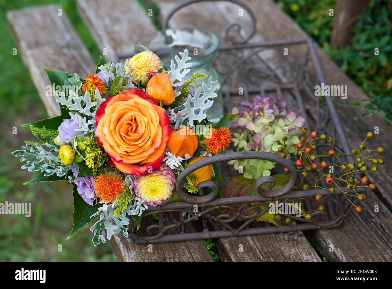 Colorful flower bouquet on a garden bench Stock Photo - Alamy