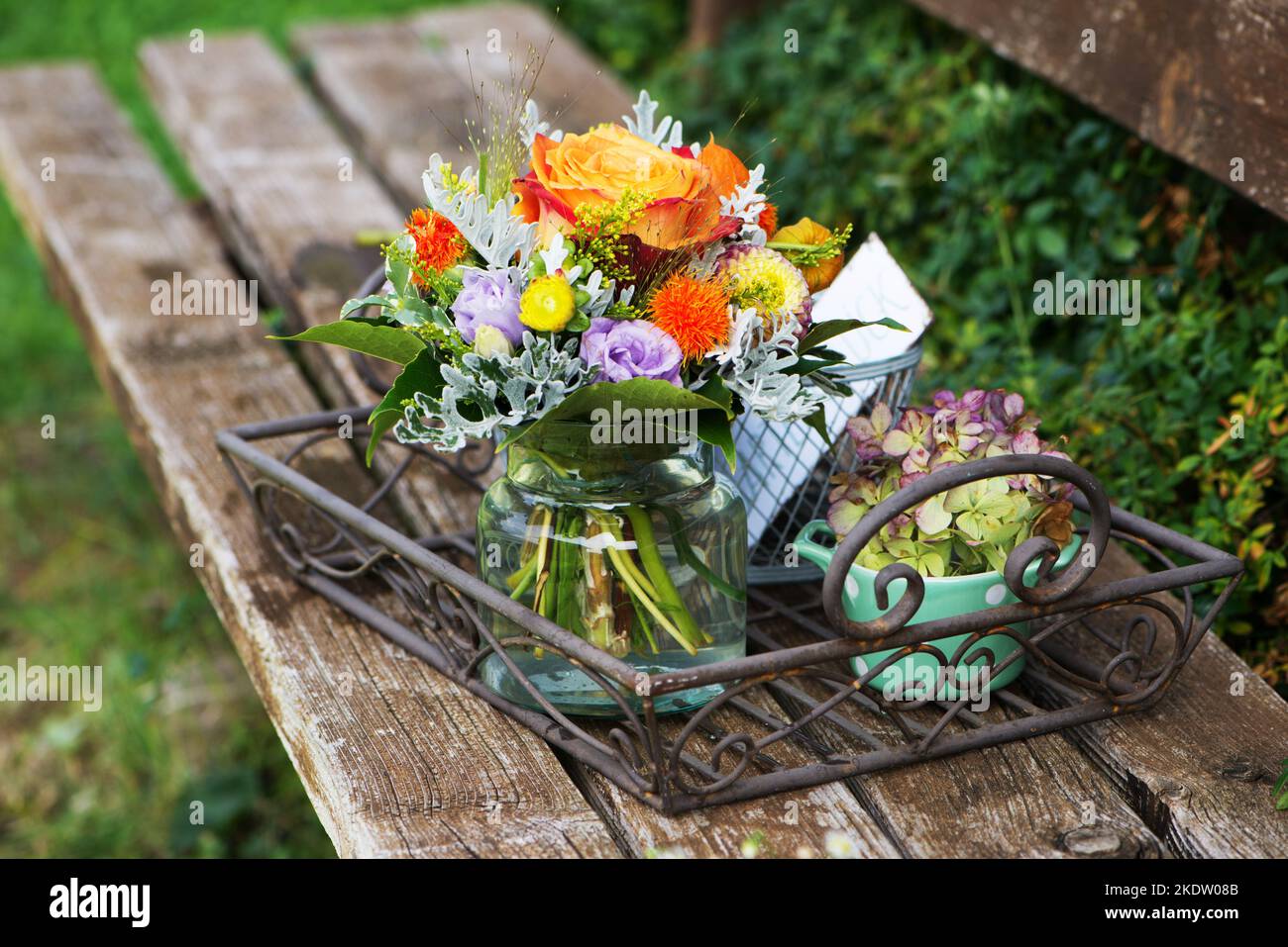 Colorful flower bouquet on a garden bench Stock Photo - Alamy