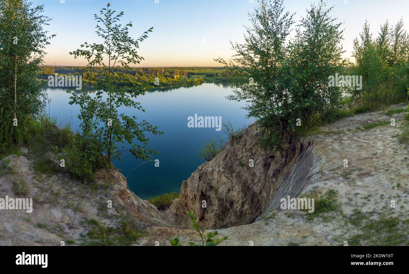 Cliff on the shore of the quarry in the evening . Vsevolozhsk ...