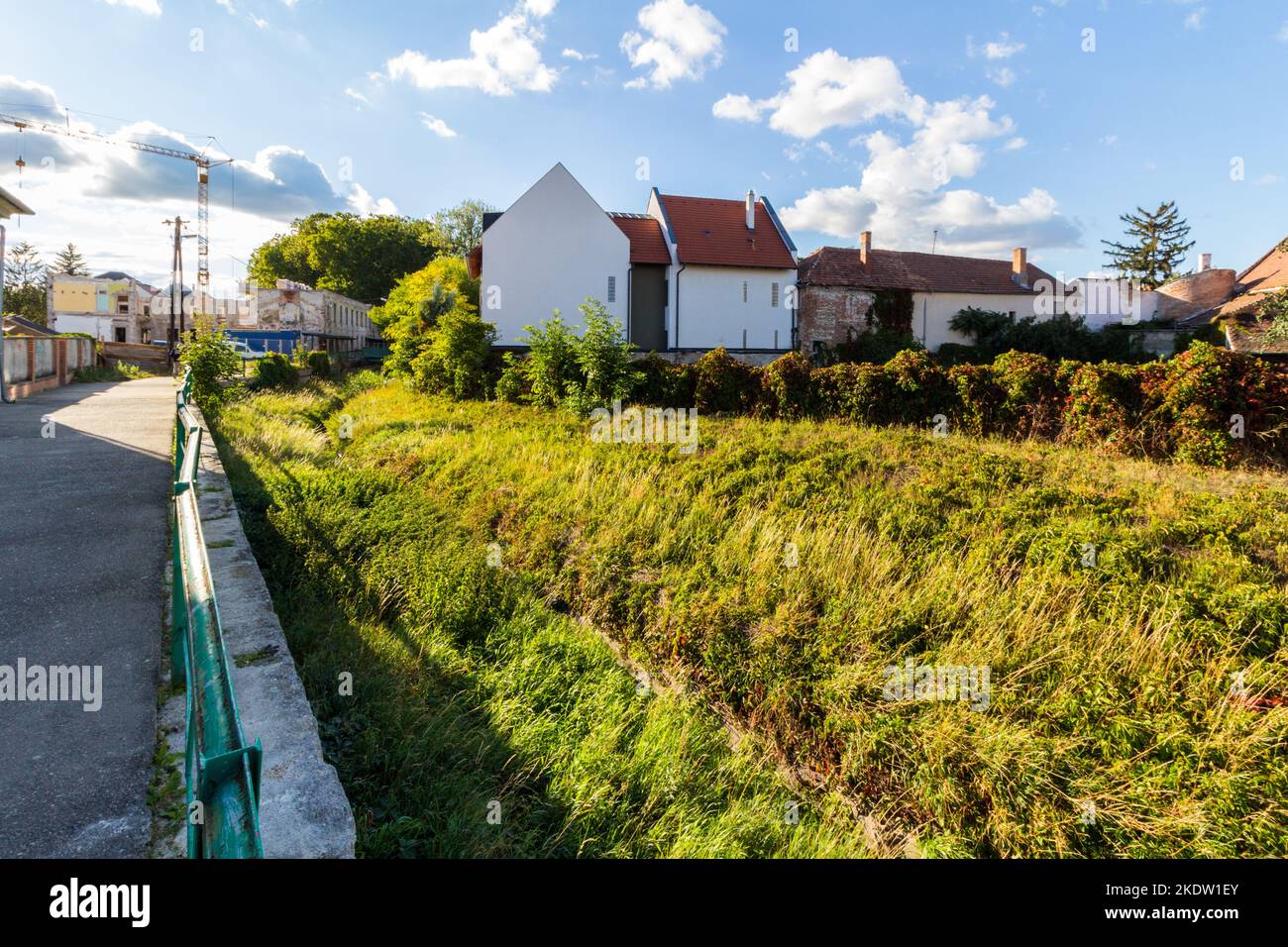 River bed of brook Ikva with thick grass vegetation and low water level ...