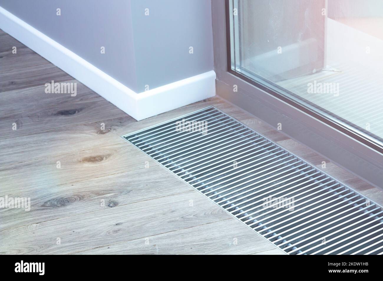 The floor convector heats a metal grate built into the floor next to ...