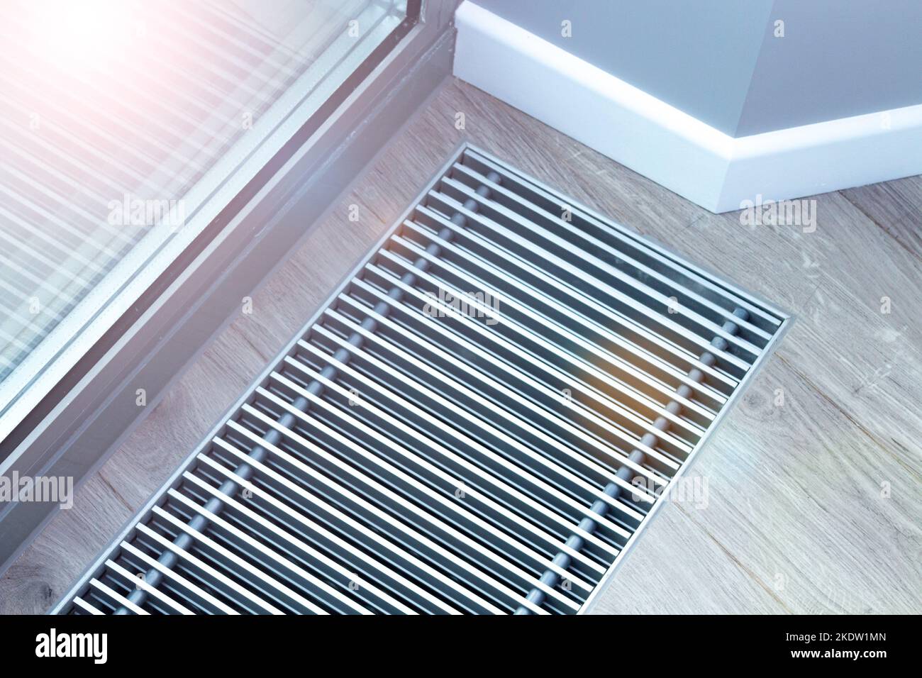 The floor convector heats a metal grate built into the floor next to ...