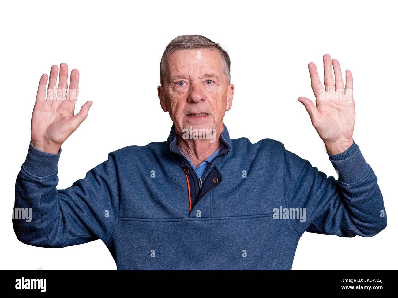 Senior adult male with hands raised and worried expression as he ...