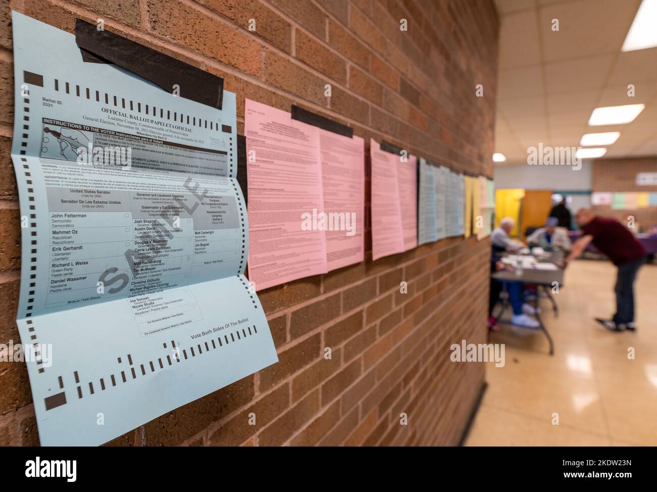 A sample ballot and rules for voting line a polling place wall. (Photo ...