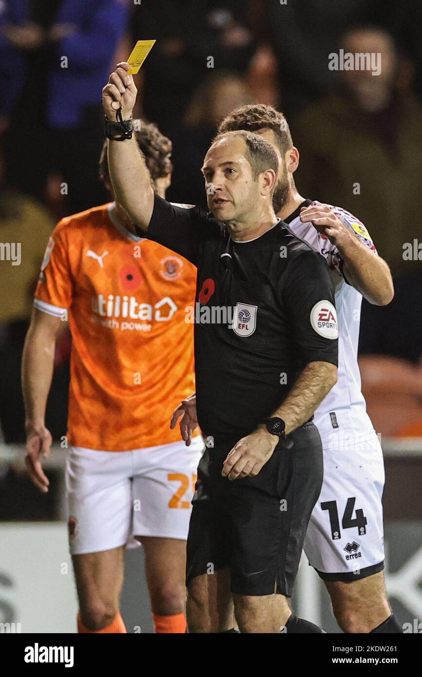 Referee Jeremy Simpson gives Dominic Thompson #23 of Blackpool a yellow ...