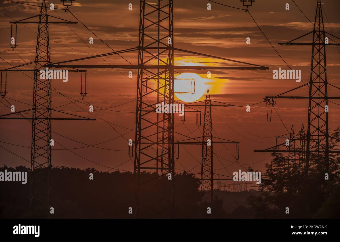 Power poles in front of sunset in backlight Stock Photo - Alamy
