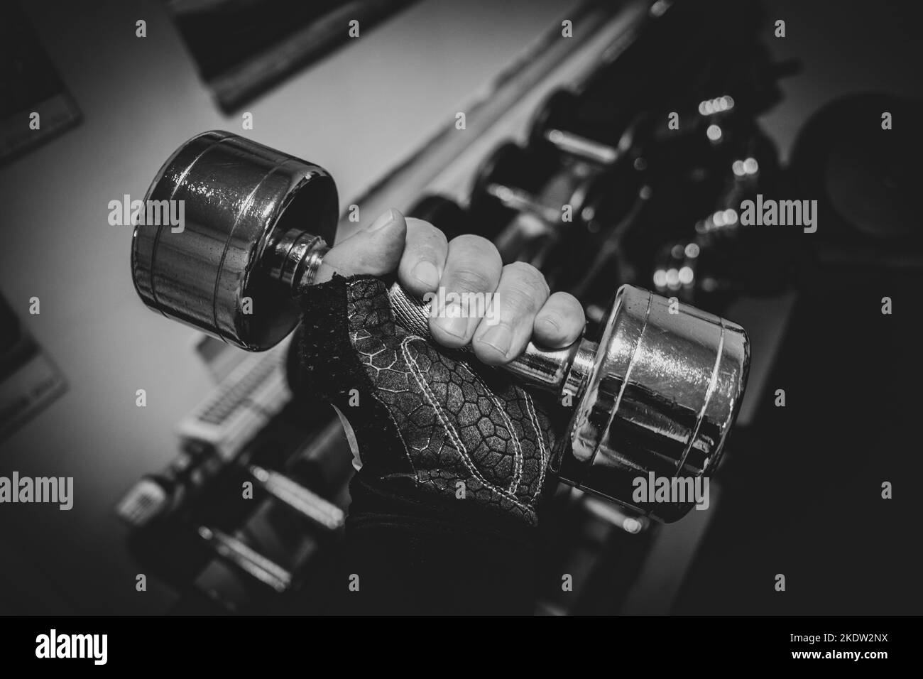 in a hand is a dumbbell Stock Photo - Alamy