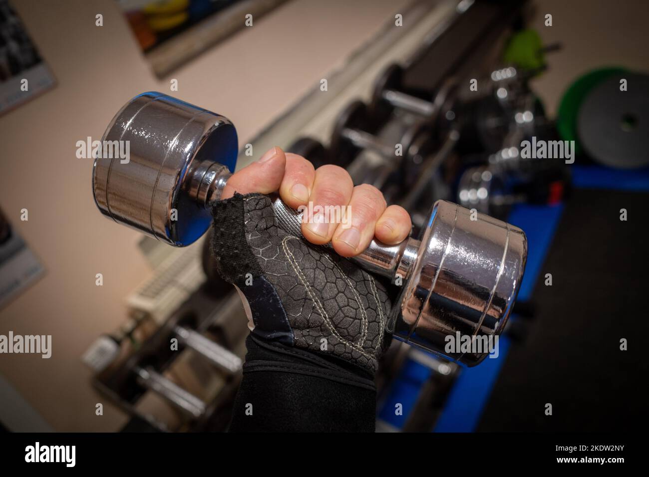 in a hand is a dumbbell Stock Photo - Alamy