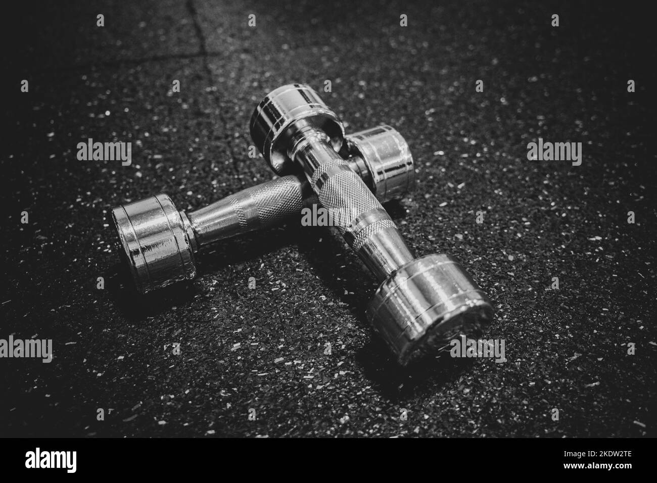 on the floor are two small dumbbells Stock Photo - Alamy
