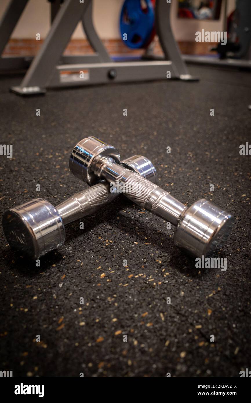 on the floor are two small dumbbells Stock Photo - Alamy