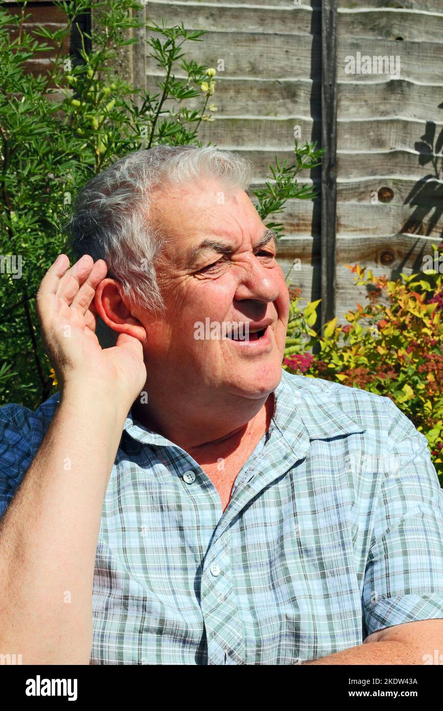 Elderly or senior man holding his hand to his ear unable to hear. hard ...
