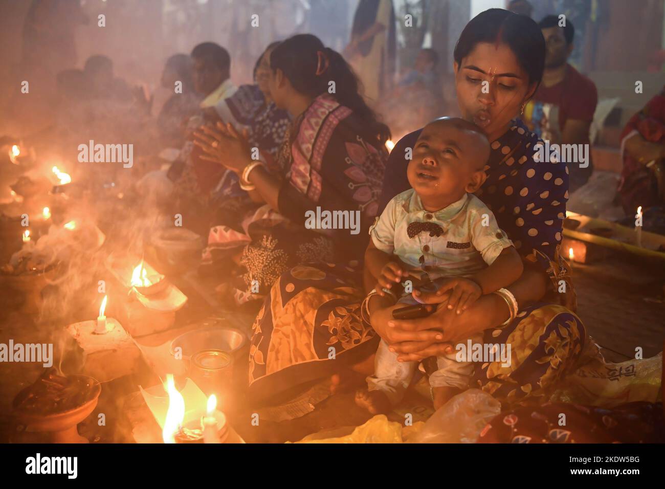 A child seen crying as her mother offers prayers at the Shri Shri ...