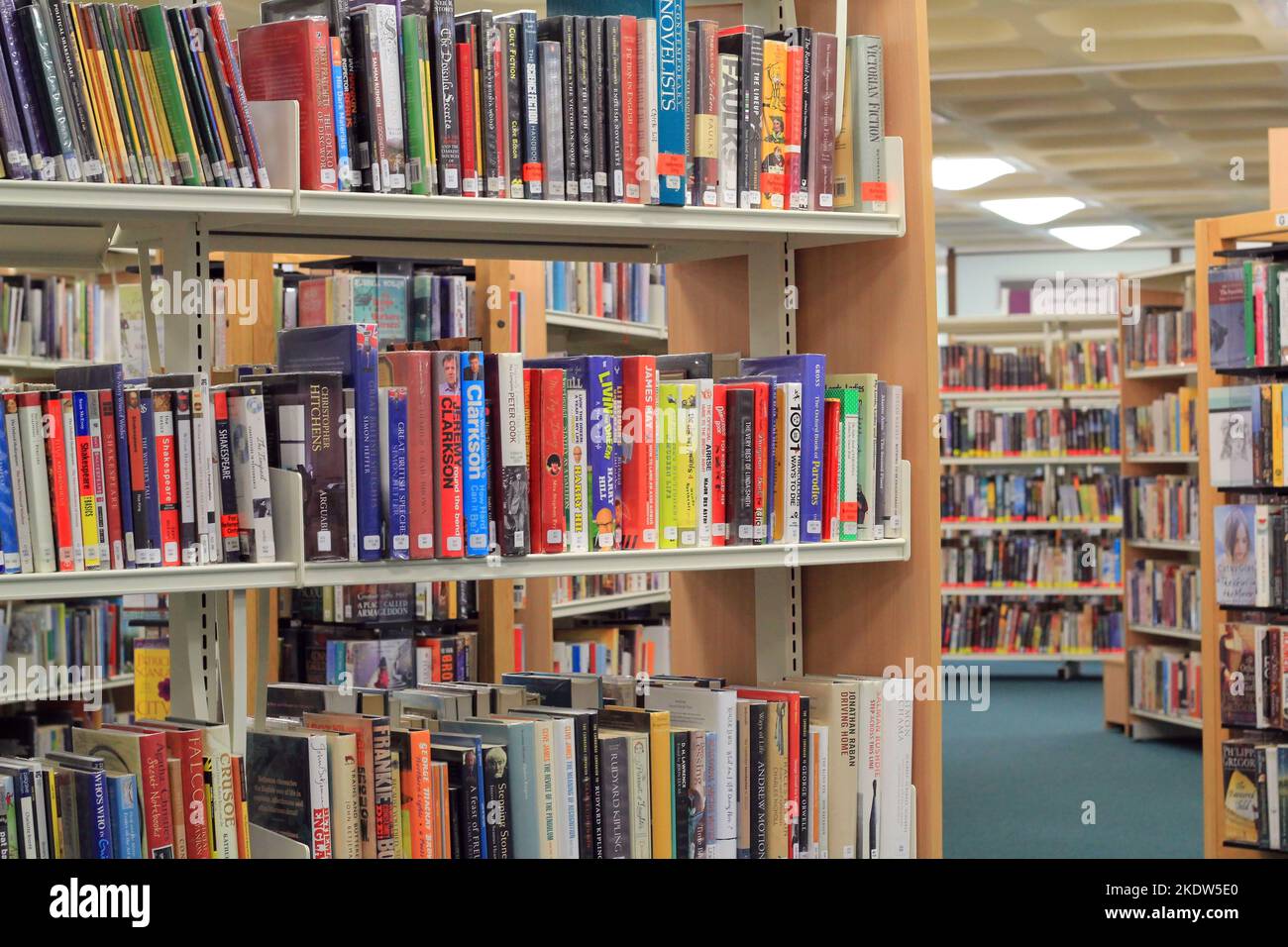 Inside a library. Bookshelves displaying various books to borrow and ...